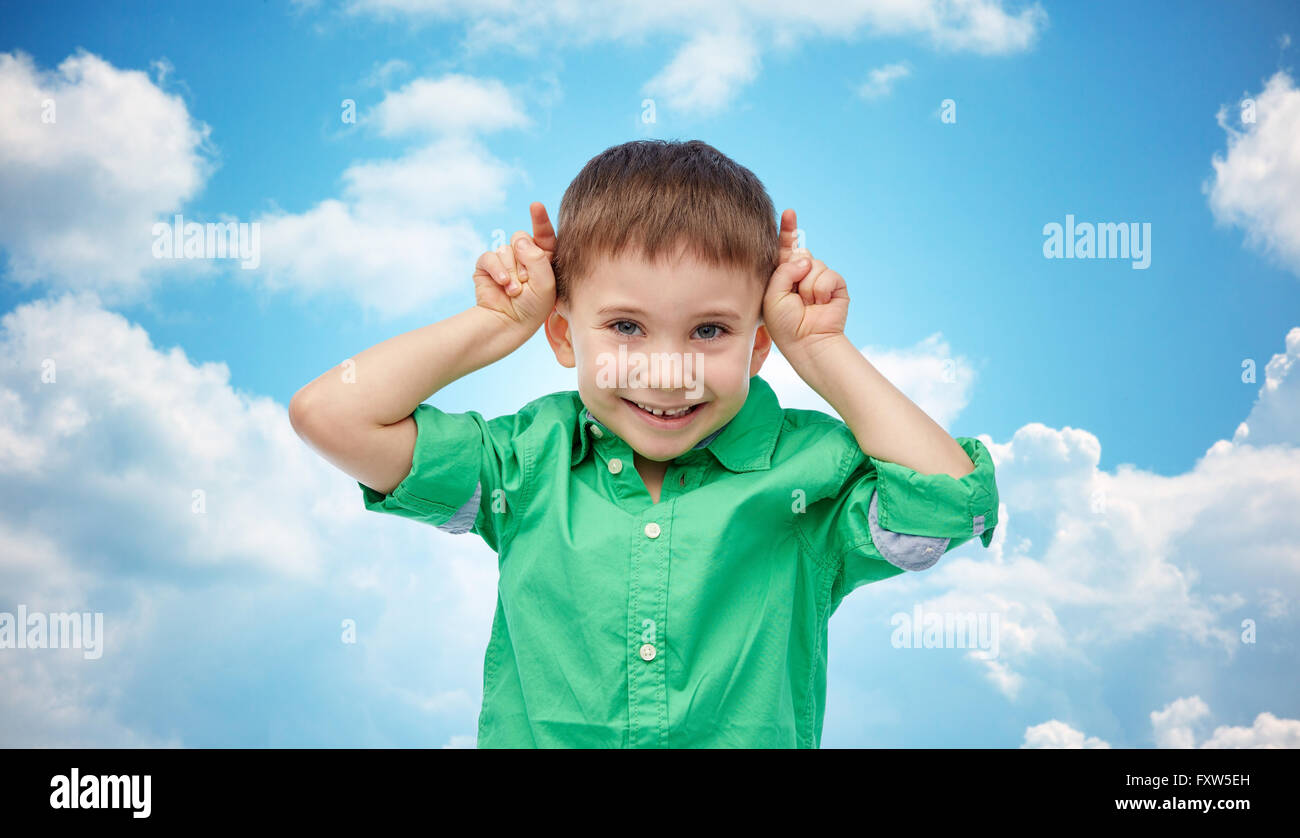 happy little boy having fun and making horns Stock Photo - Alamy