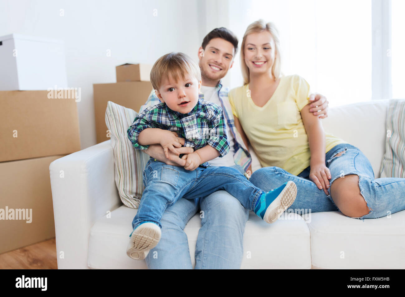 happy family with boxes moving to new home Stock Photo - Alamy