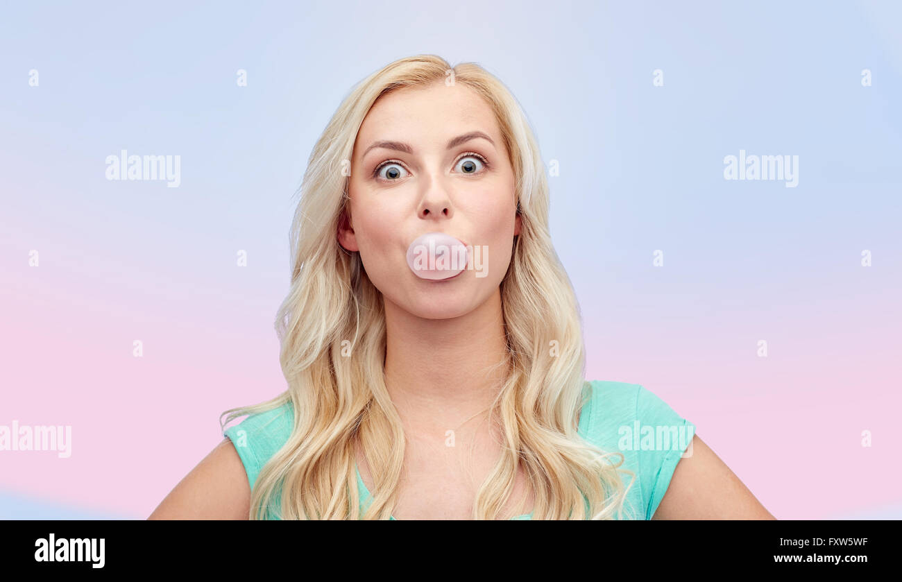 happy young woman or teenage girl chewing gum Stock Photo - Alamy