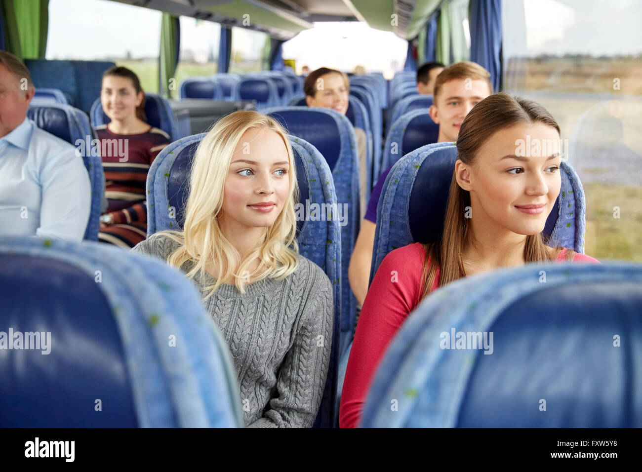 happy young women riding in travel bus Stock Photo - Alamy