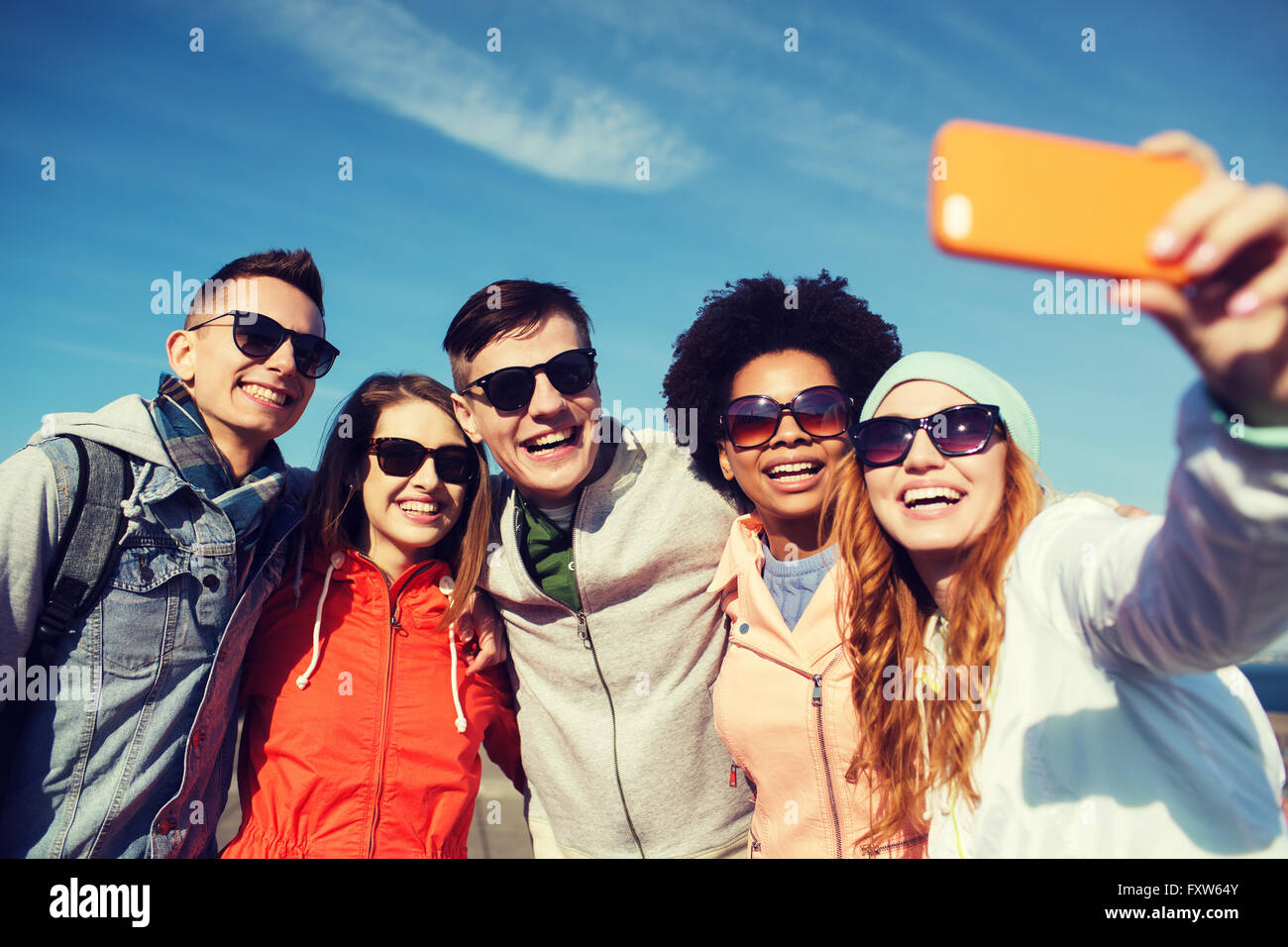 smiling friends taking selfie with smartphone Stock Photo - Alamy