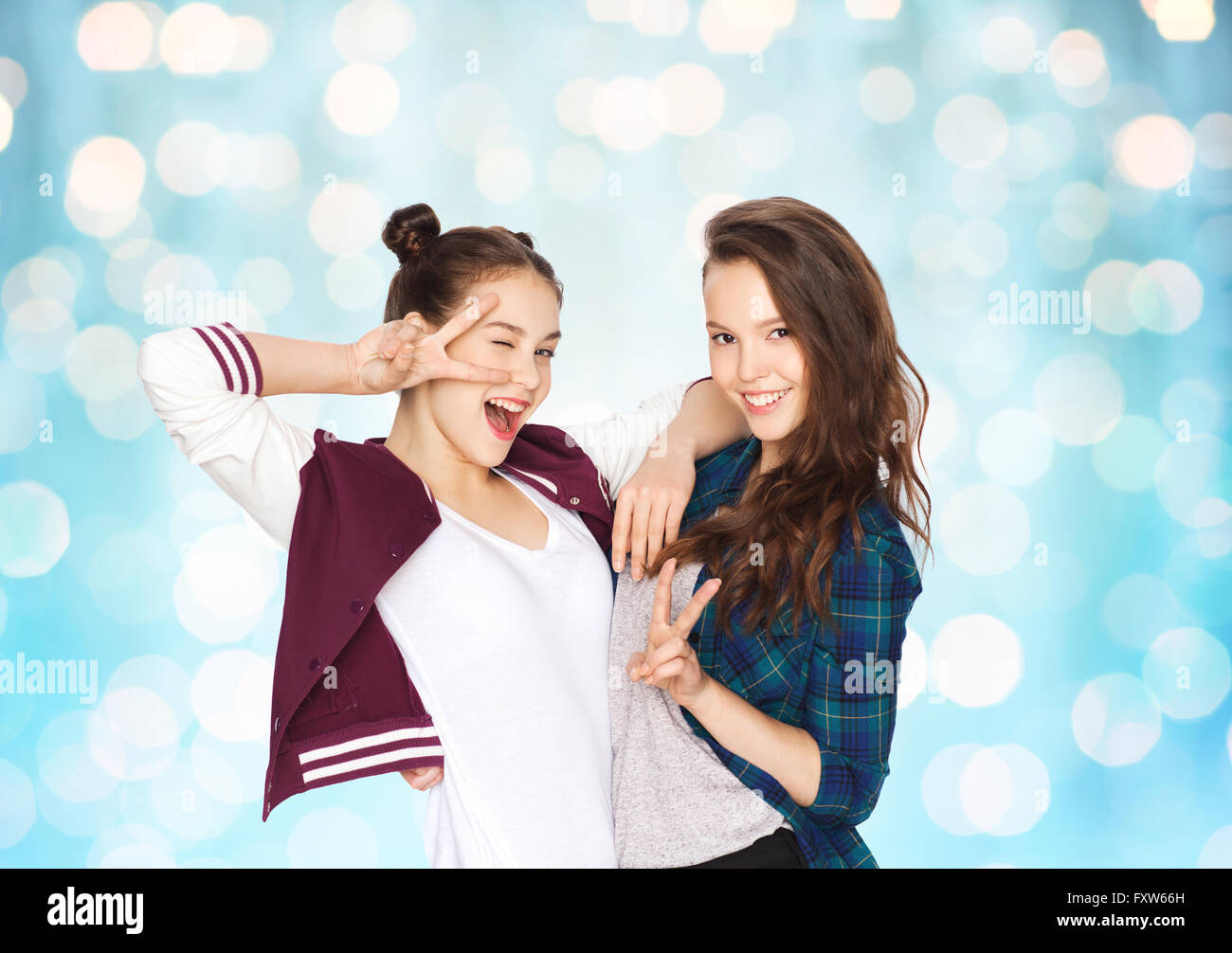 happy pretty teenage girls showing peace hand sign Stock Photo - Alamy