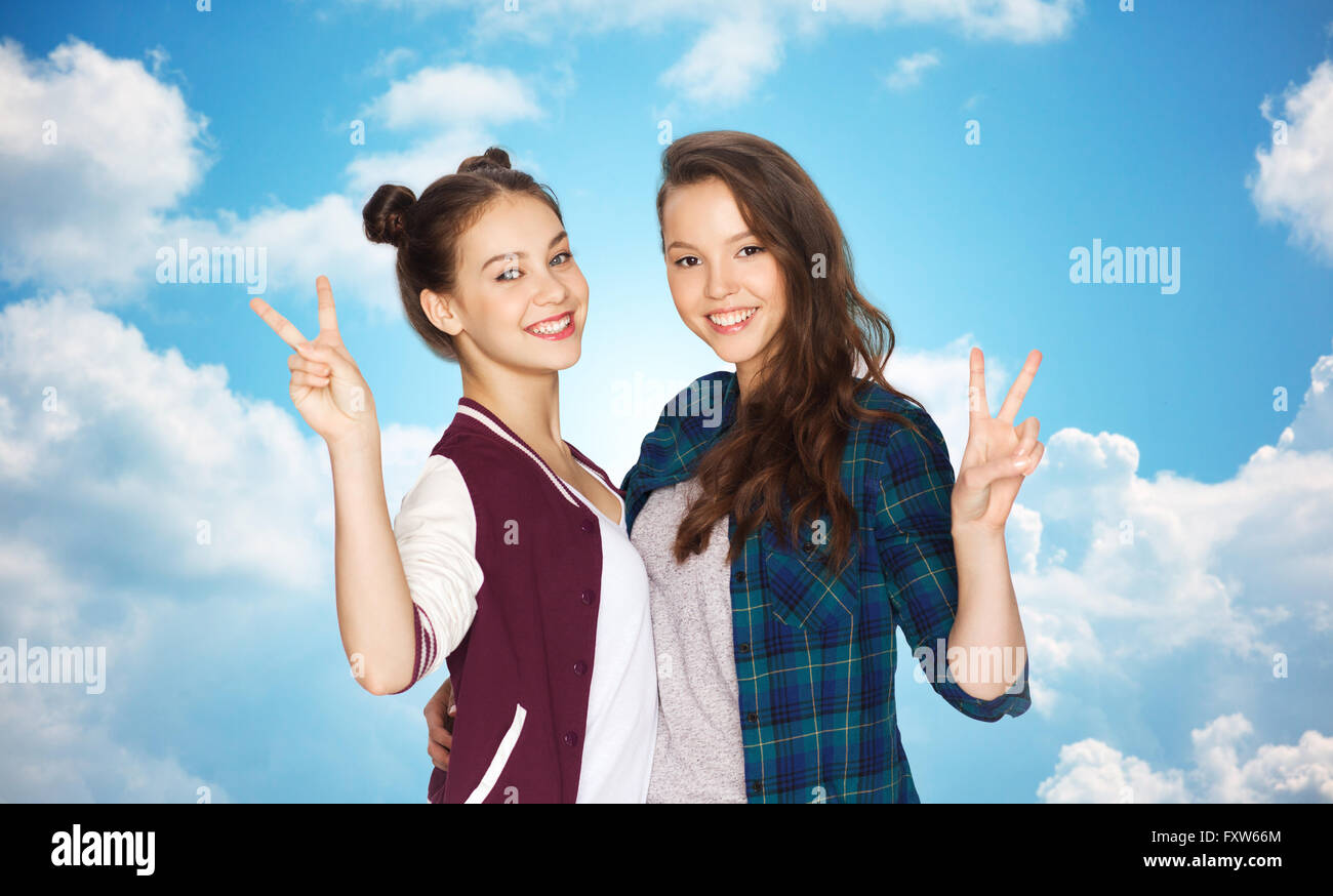 happy teenage girls hugging and showing peace sign Stock Photo - Alamy