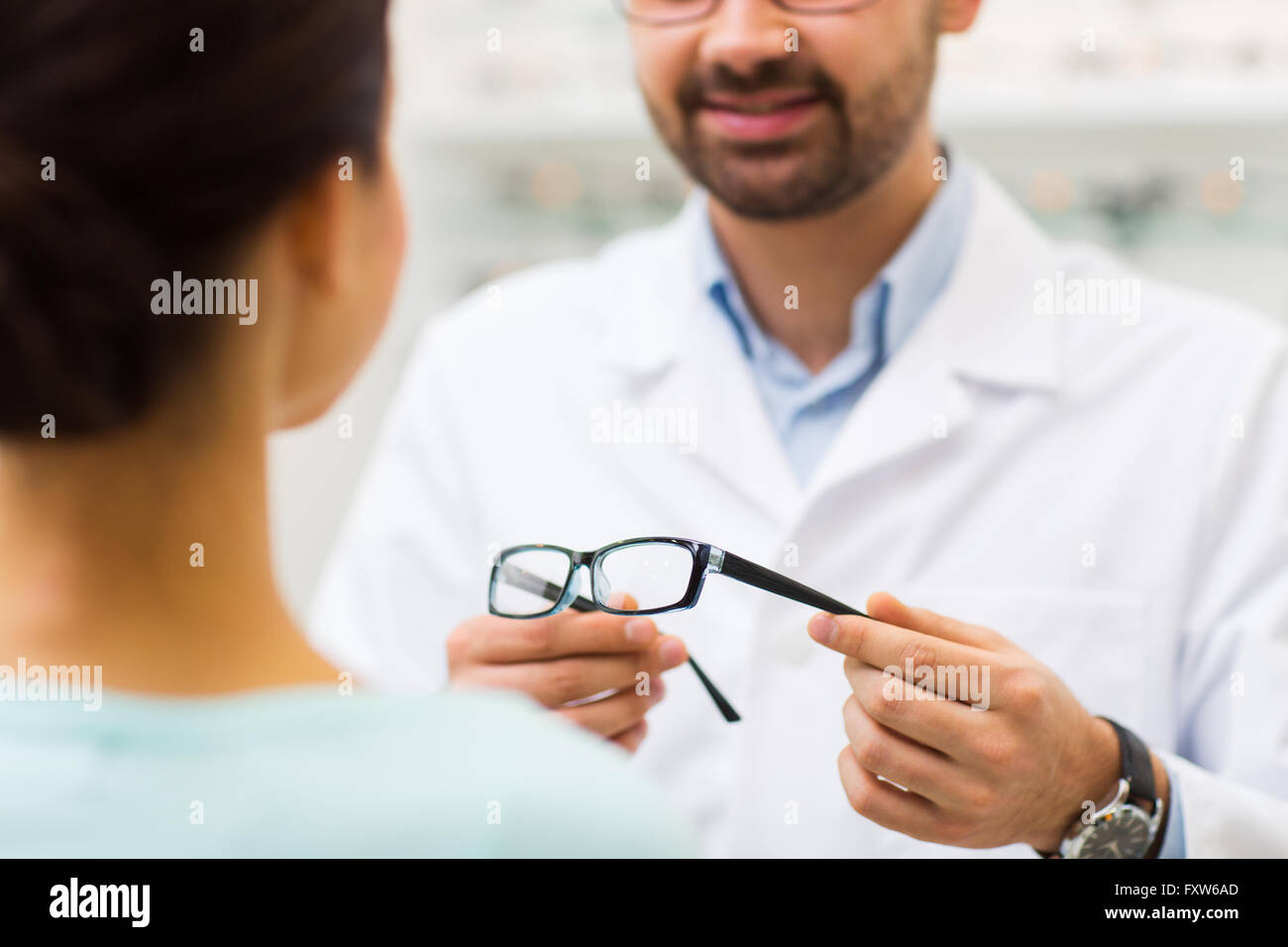 close up of optician with glasses at optics store Stock Photo - Alamy
