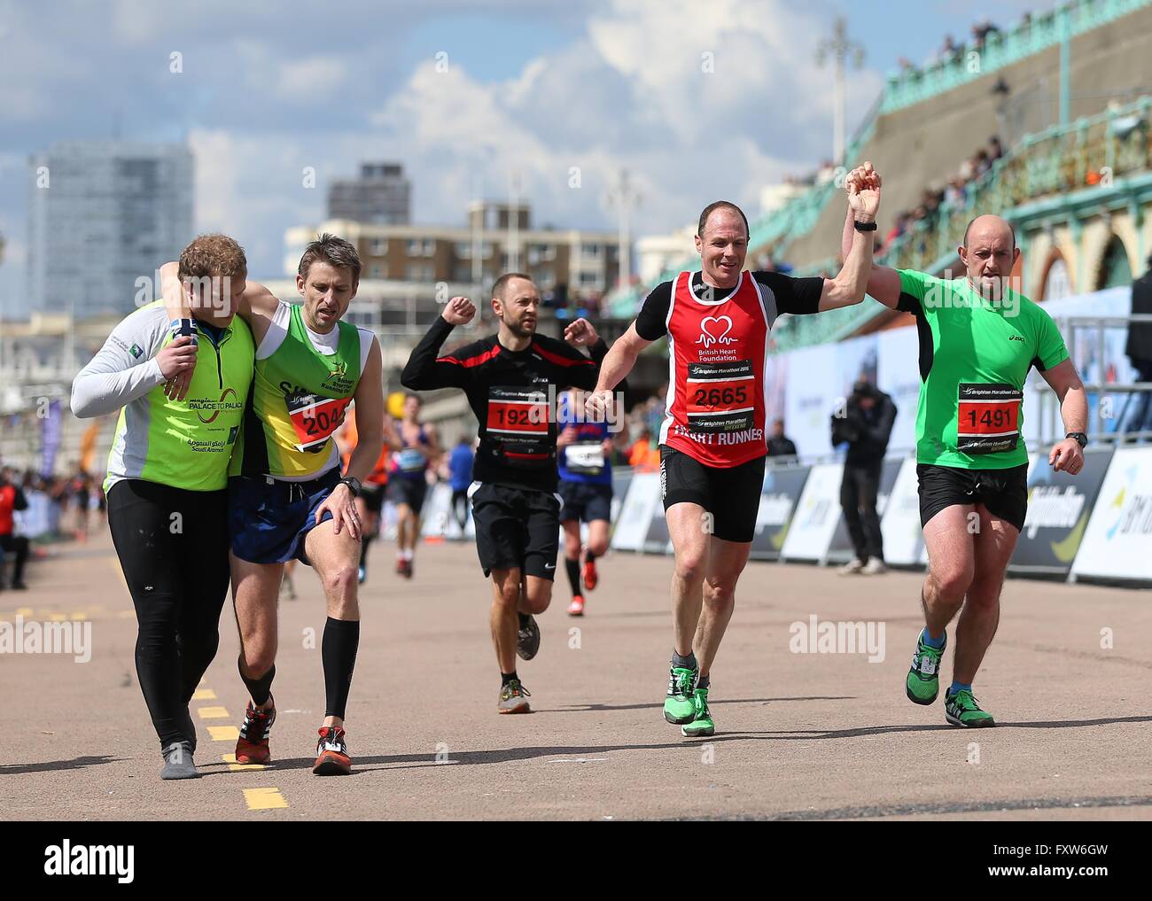 A runner is helped across the finish line during the 2016 Brighton ...
