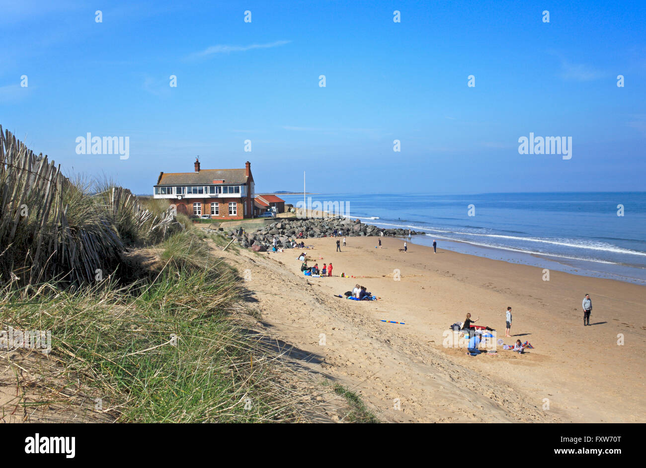 Families enjoying the spring sunshine on the beach at Brancaster ...