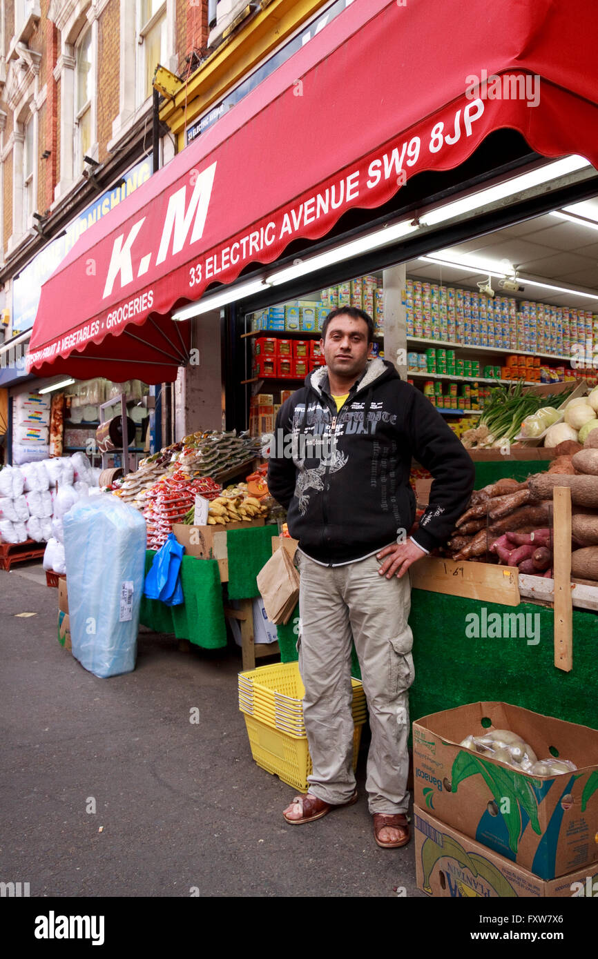 K.M. - Portrait of a grocer outside his shop, Electric Avenue market ...