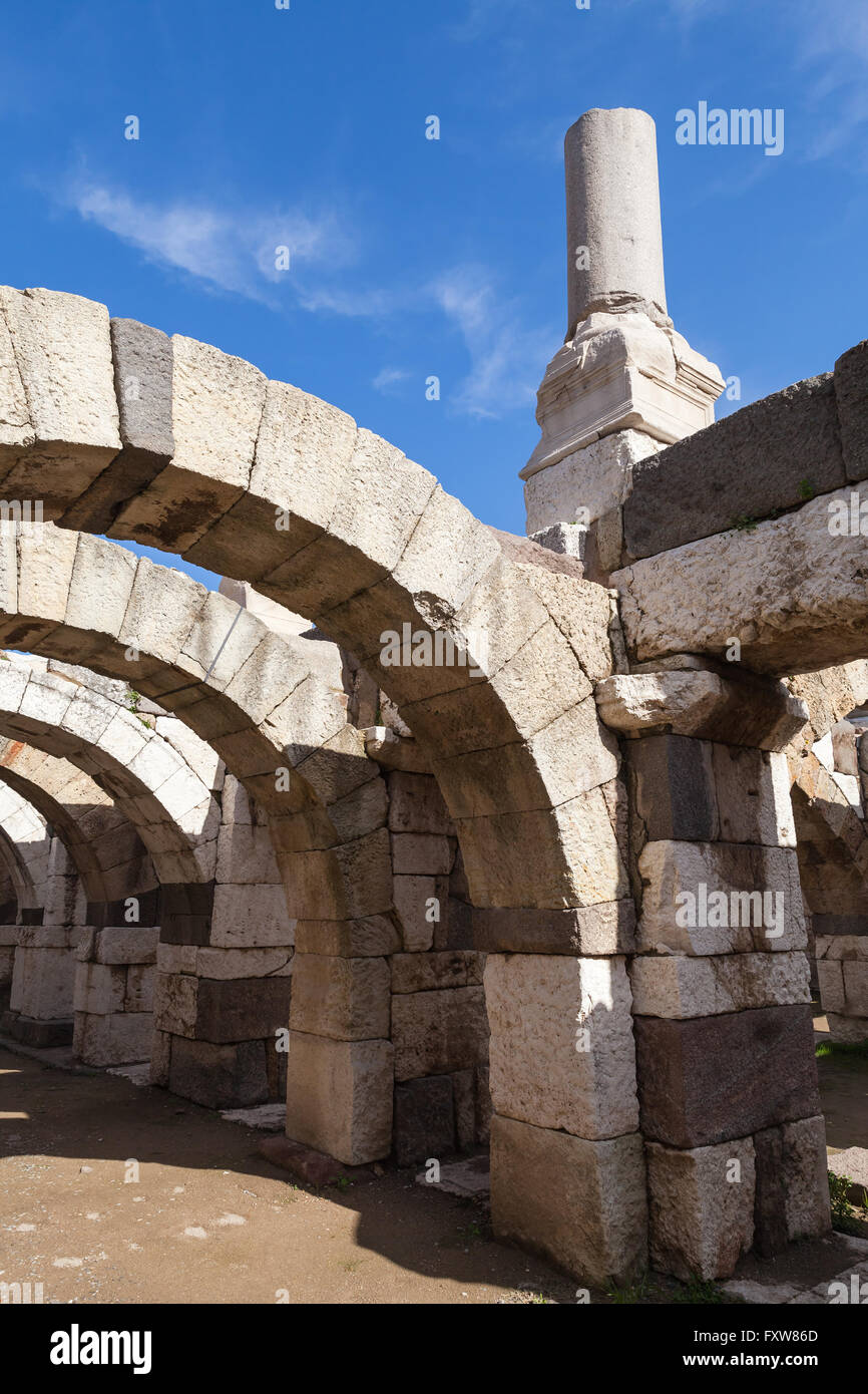Ancient white broken columns and arches on blue sky background ...