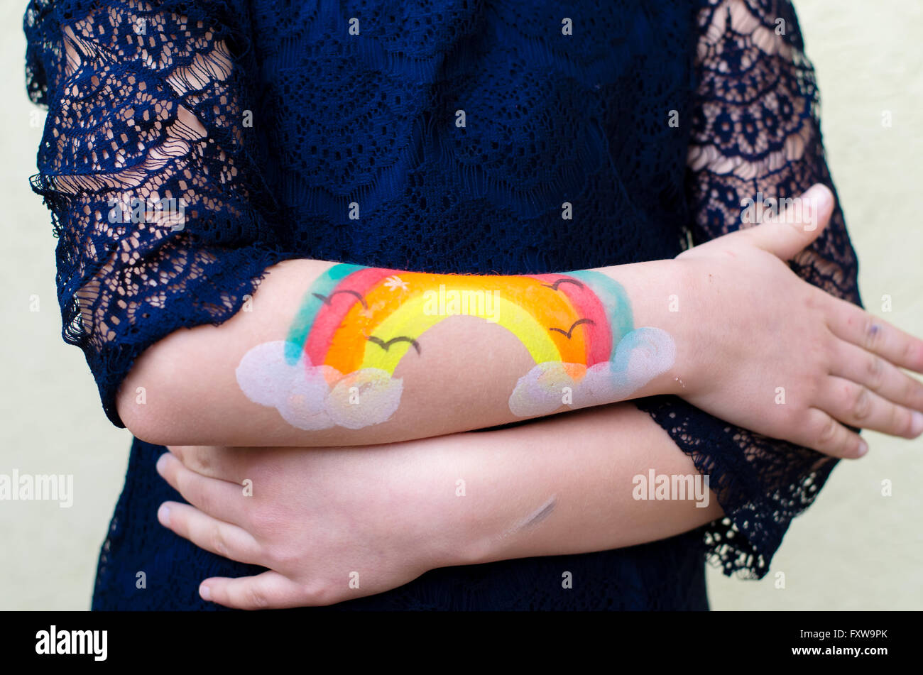 colorful rainbow painting in kids hand Stock Photo - Alamy