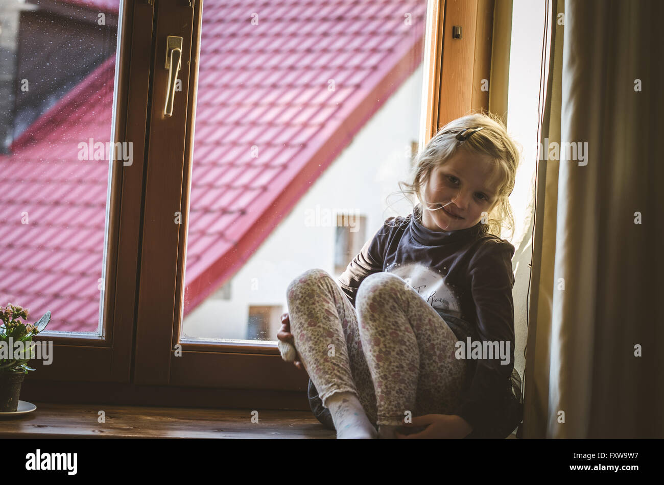 lovely girl sitting by the window Stock Photo - Alamy