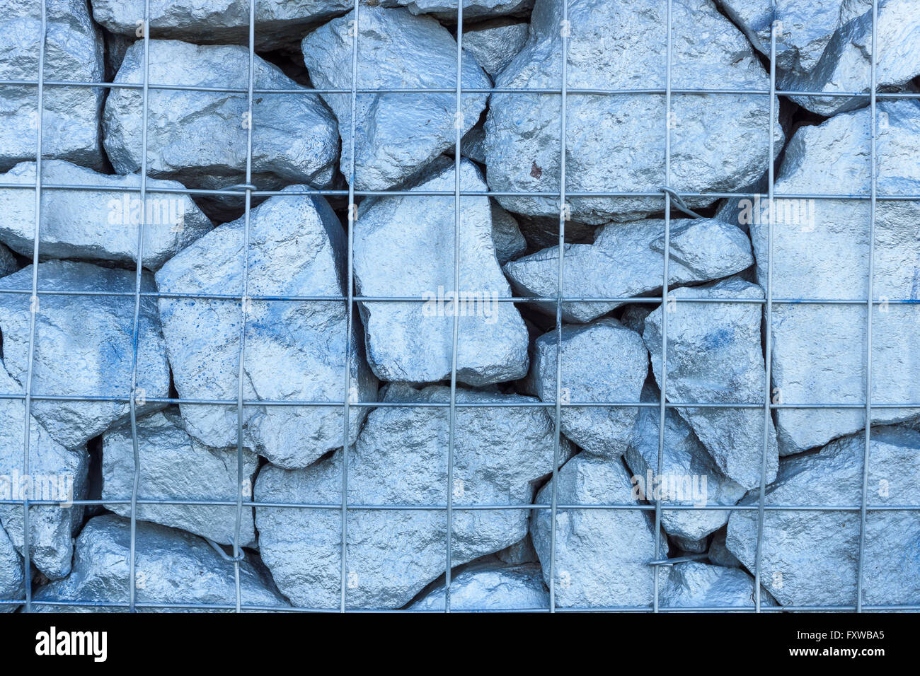 Folded large colored stones and reinforced wire mesh. Background Stock ...