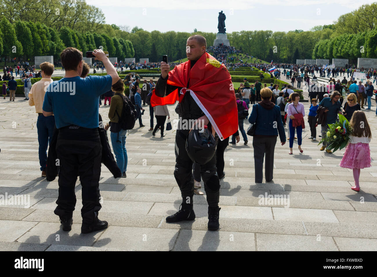 Victory Day. The man with the flag of the Soviet Union is photographed ...
