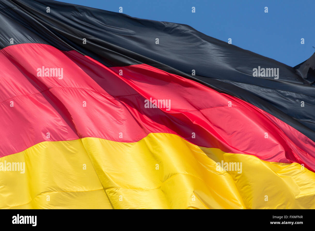 german flag, national flag of germany on blue sky Stock Photo - Alamy