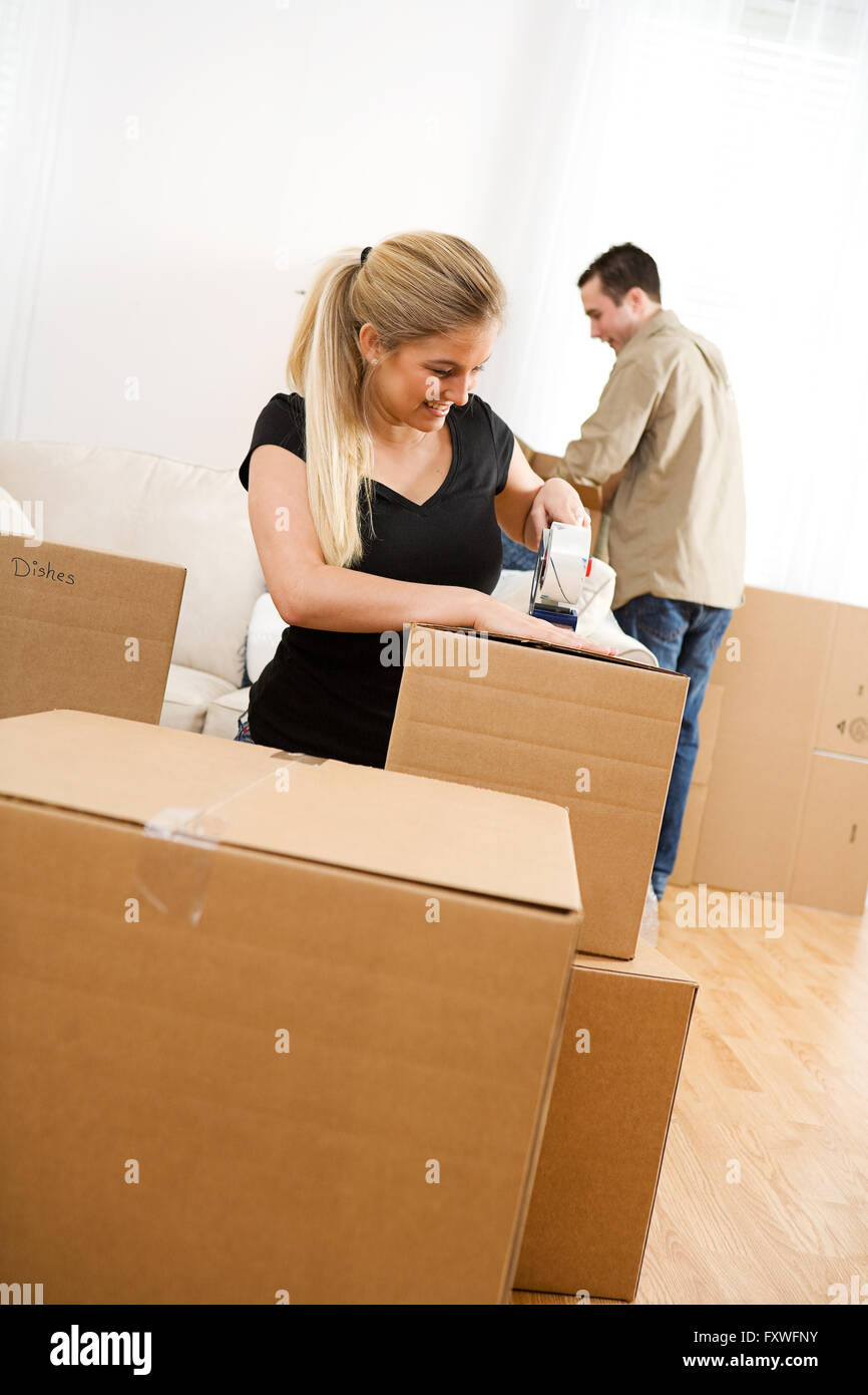 Young couple, indoors, packing posessions in cardboard boxes Stock ...