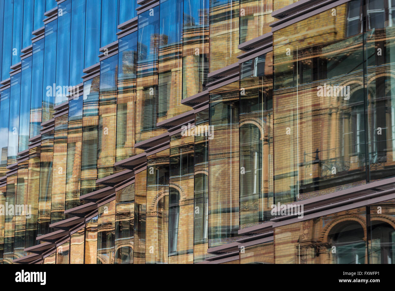 modern building and old building reflection on glass facade Stock Photo ...