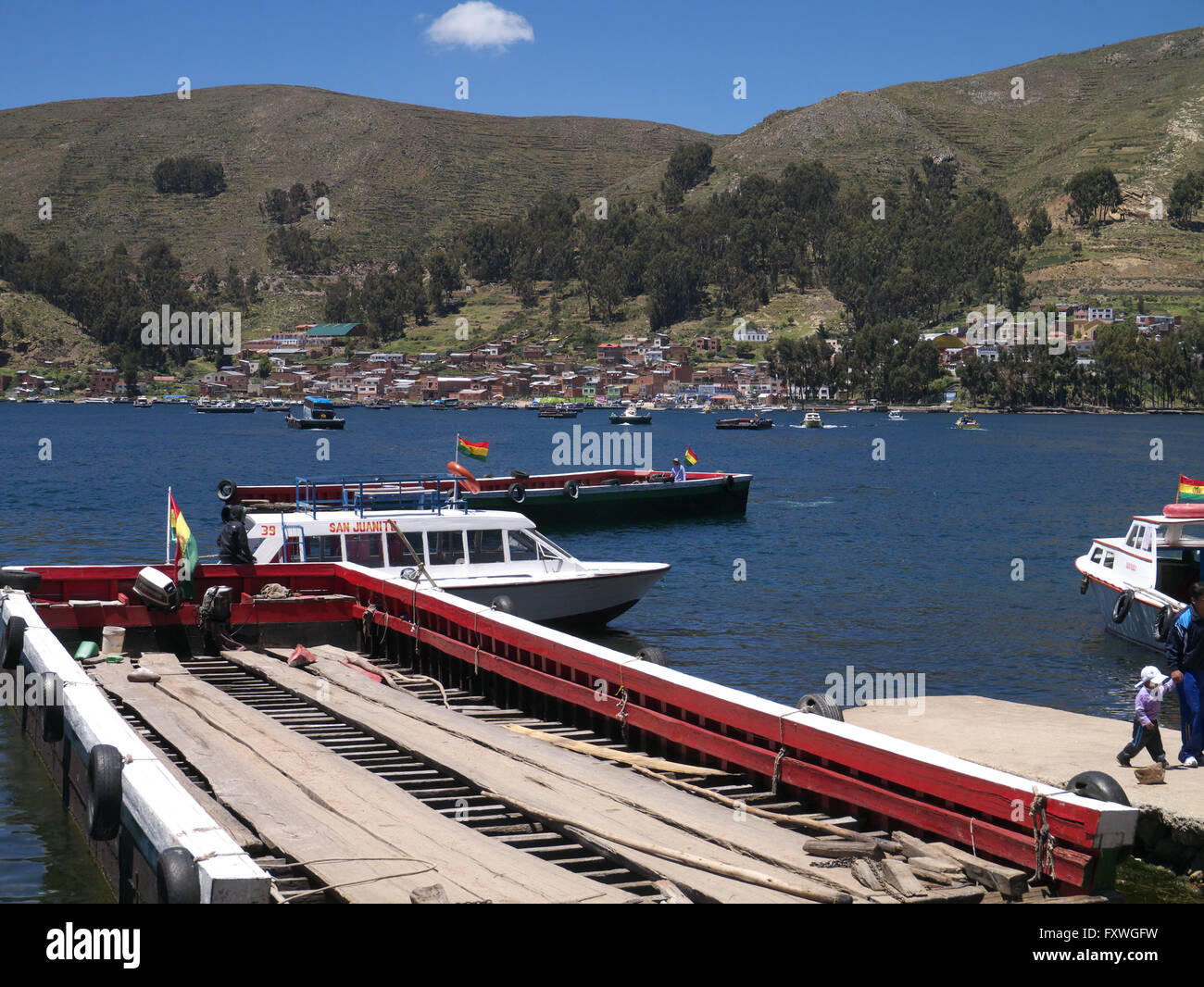 Ferries crossing Lake Titicaca with lorries and cars loaded on small ...