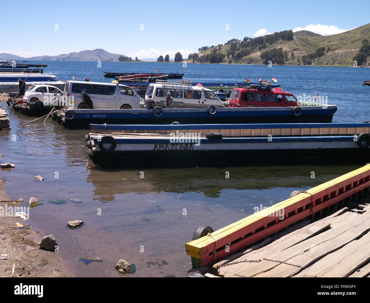 Ferries crossing Lake Titicaca with lorries and cars loaded on small ...