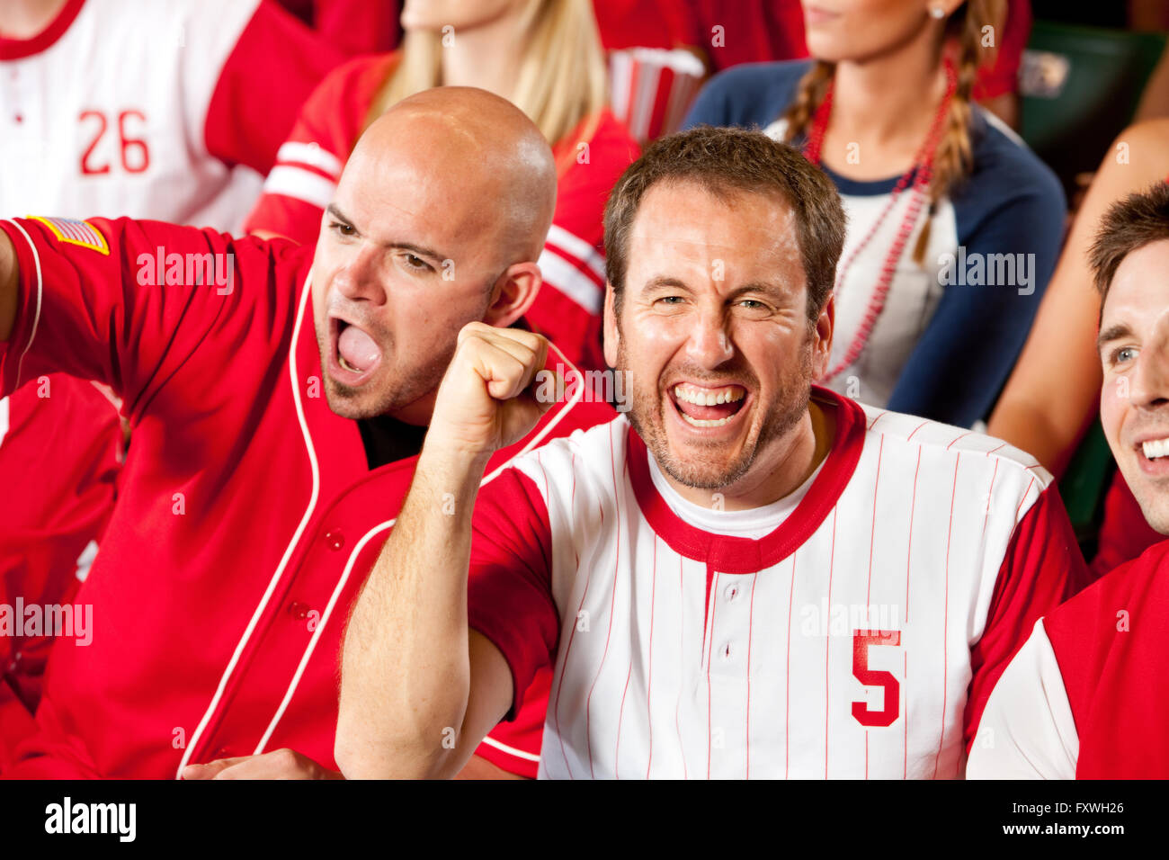 Extensive series of a crowd of baseball fans, sitting in a stadium ...