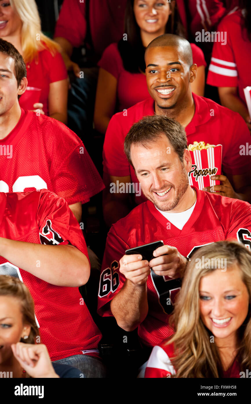 Multi-ethnic crowd of American football fans in a stadium, cheering ...