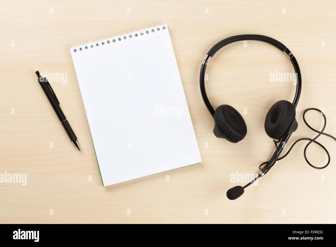 Office desk with headset and supplies. Call center table. Top veiw with ...