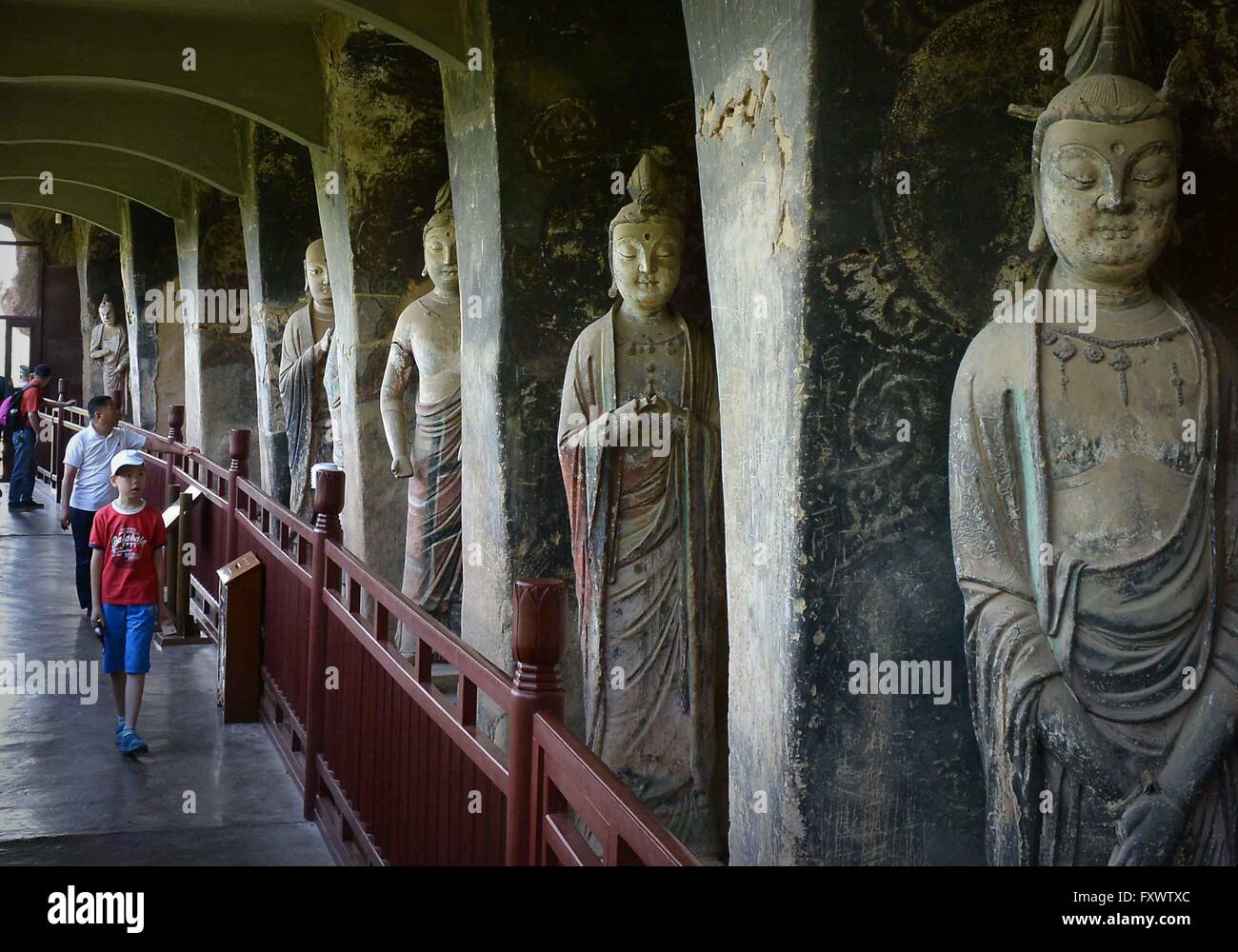Beijing, China's Gansu Province. 3rd July, 2014. Tourists view Buddha ...