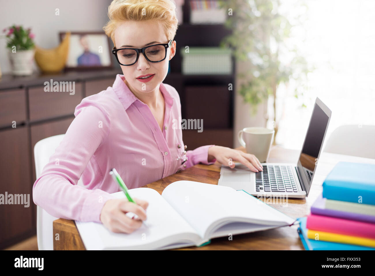 Woman writing notes desk hi-res stock photography and images - Alamy