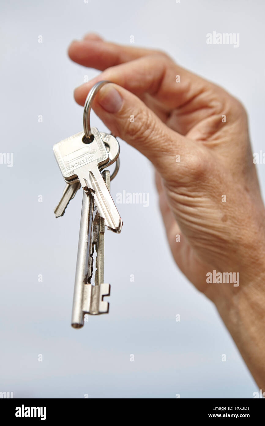 Womans hand holding bunch of keys Stock Photo - Alamy
