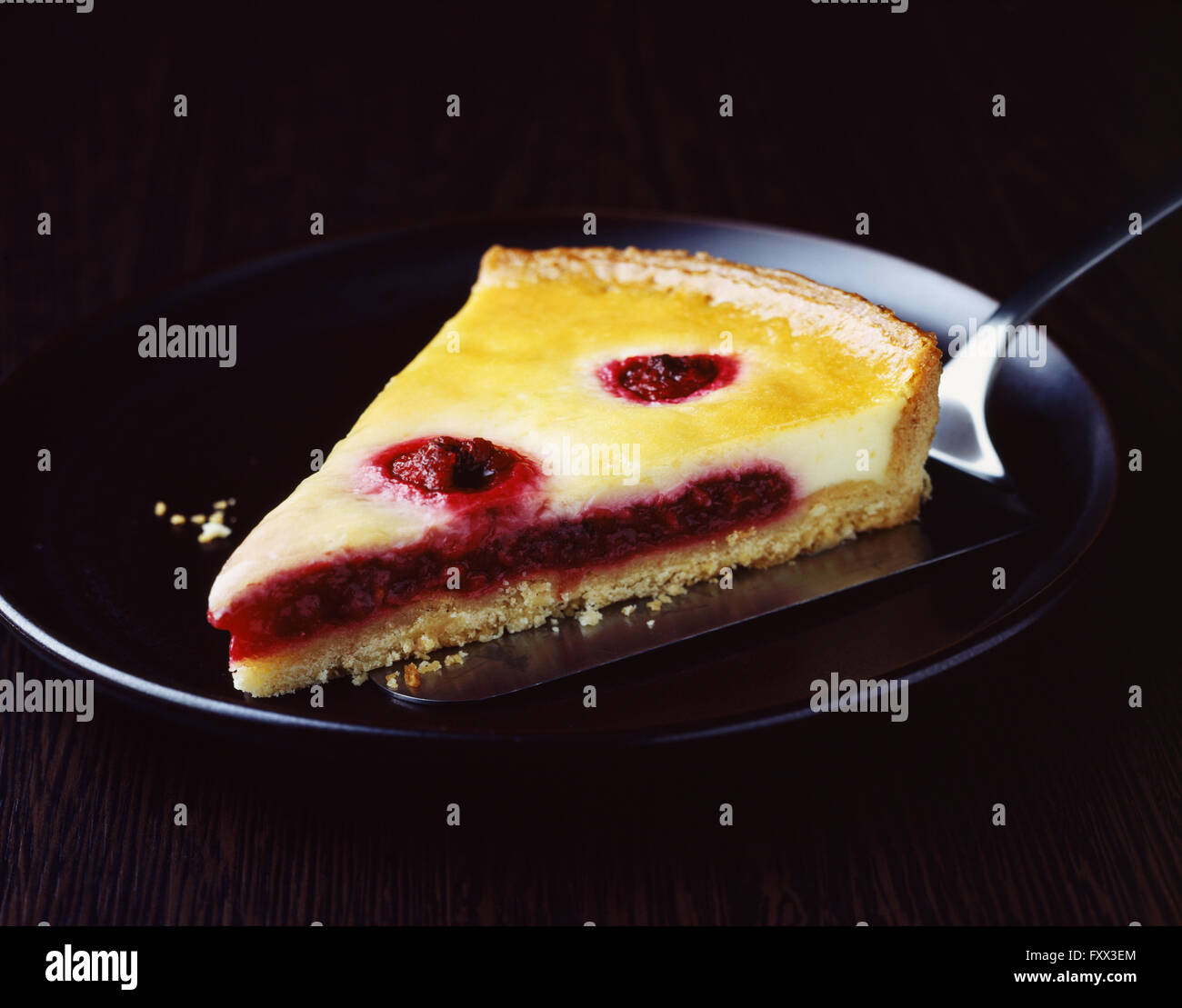 Slice of raspberry and custard tart Stock Photo - Alamy