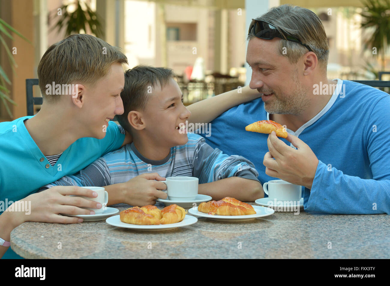 Two boys with mother at the table hi-res stock photography and images ...