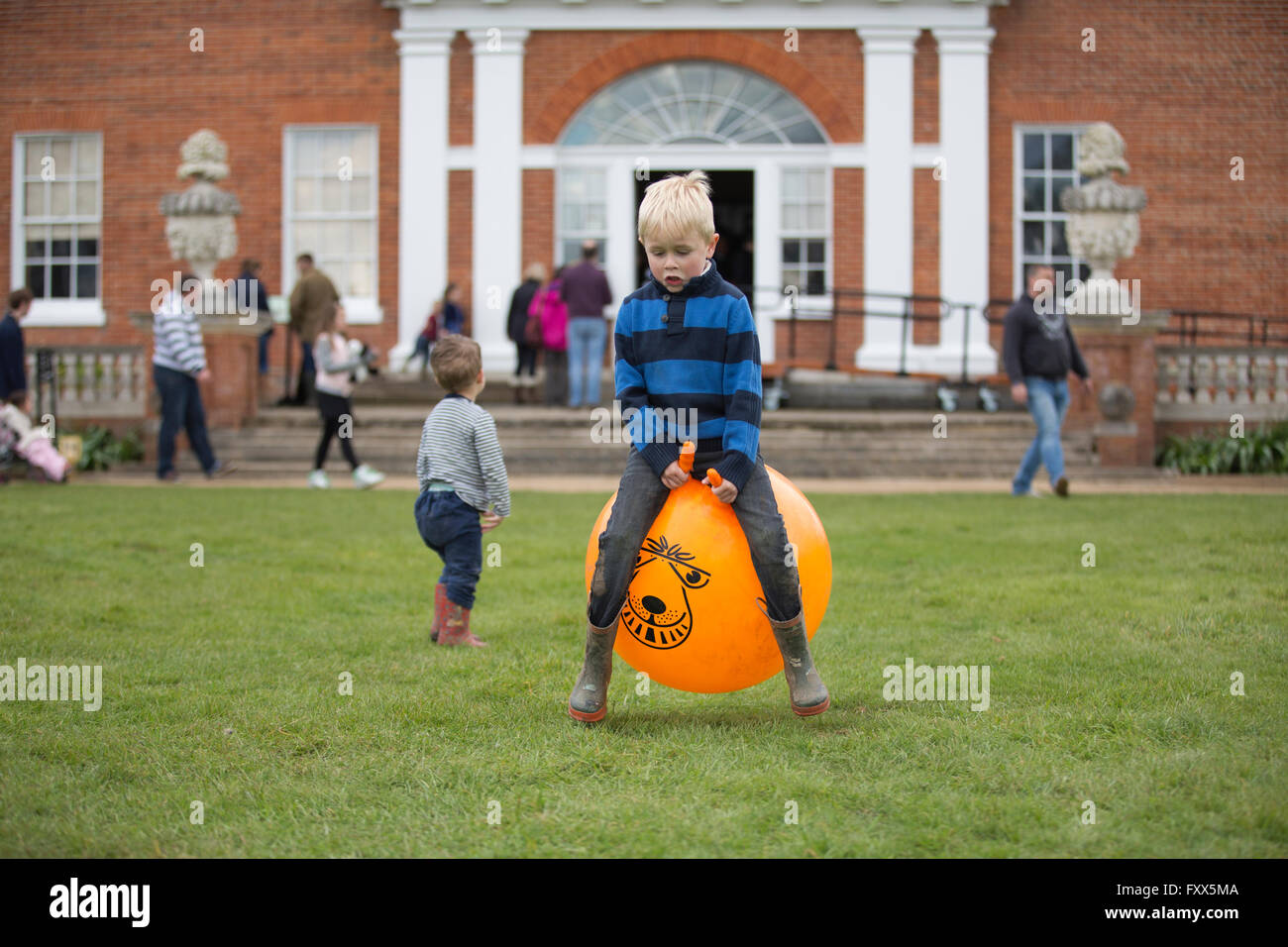 Families having fun on bouncy hoppers outside in the gardens at ...