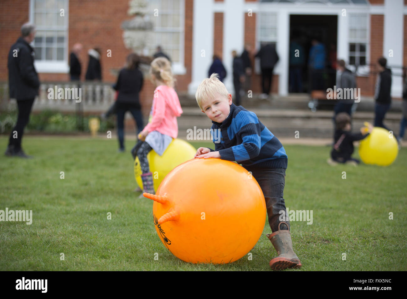 Families having fun on bouncy hoppers outside in the gardens at ...