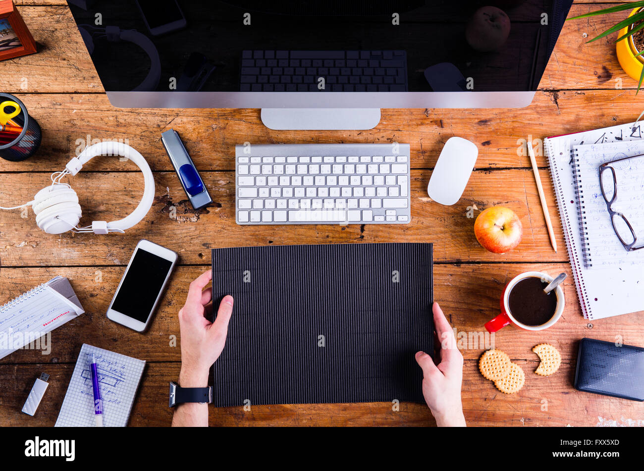 Business person working at office desk holding paper sheet Stock Photo ...