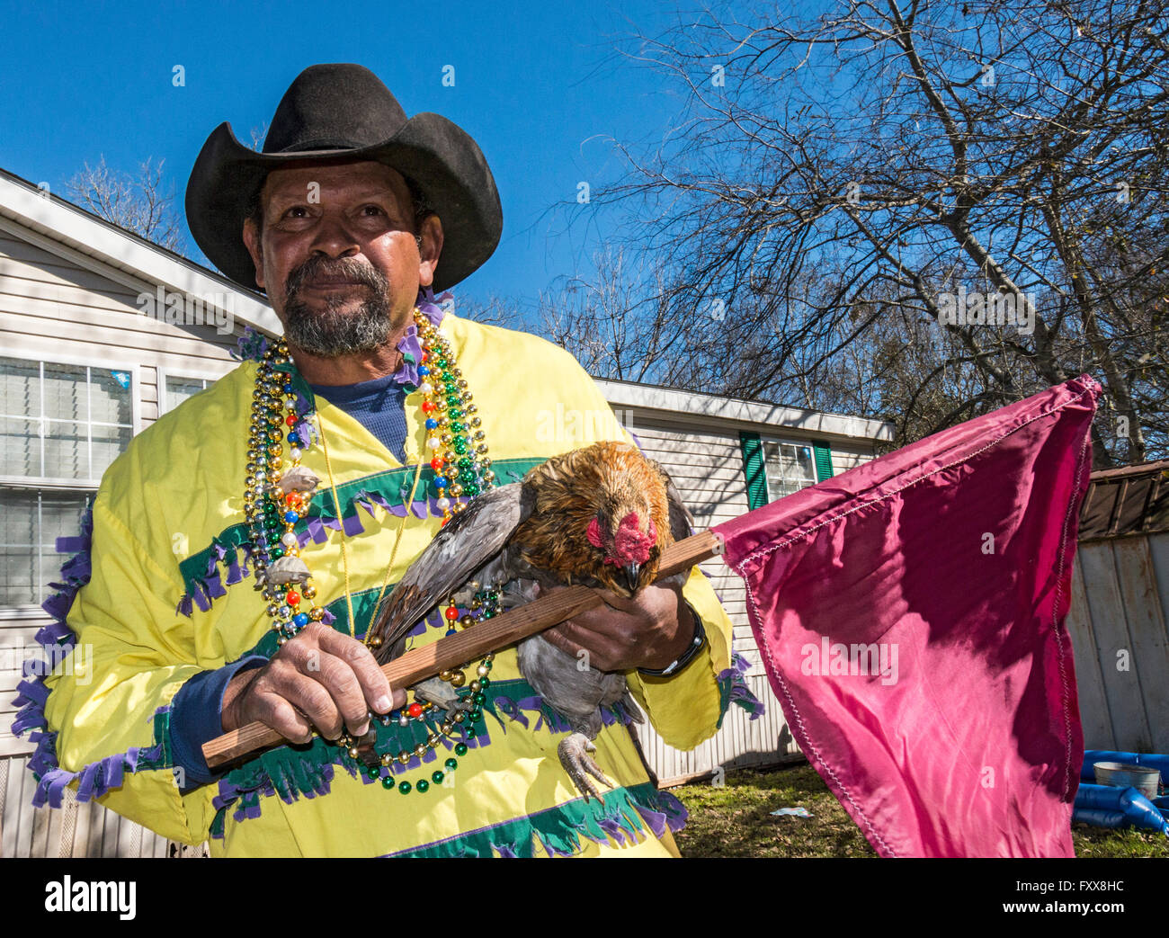 Rodney Victorian, chicken caption, holds one of his prize roosters for ...