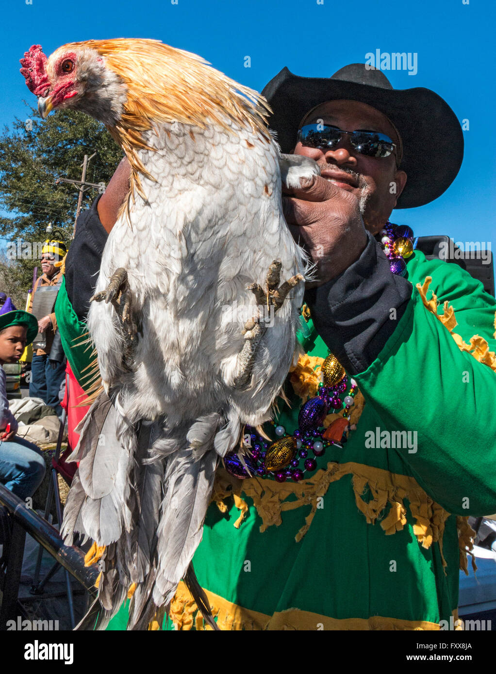 Rodney Victorian, chicken caption, holds one of his prize roosters for ...