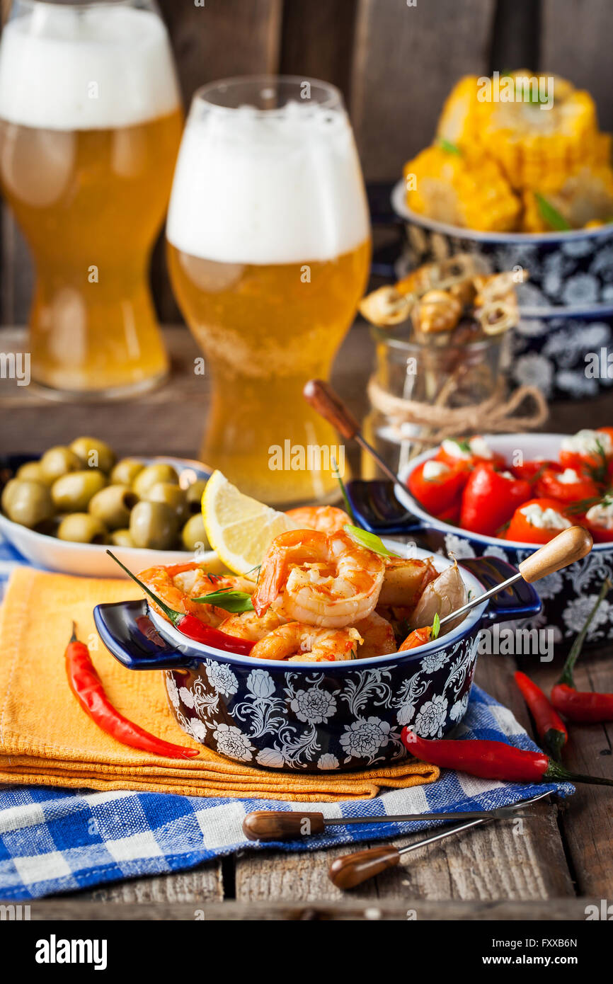 Selection of spanish tapas appetizers - shrimps, pepper, olives, corn ...
