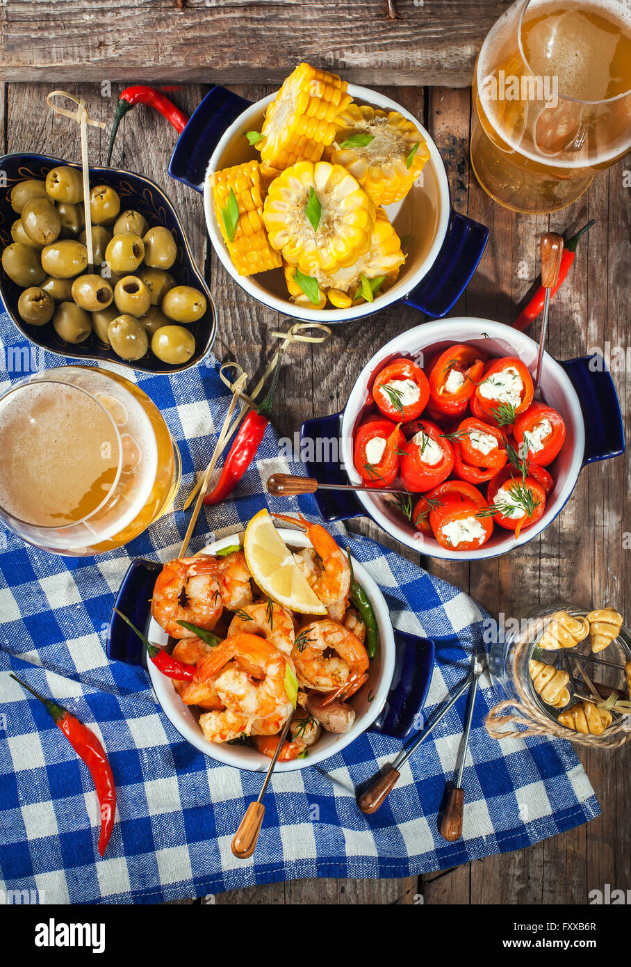 Selection of spanish tapas appetizers - shrimps, pepper, olives, corn ...