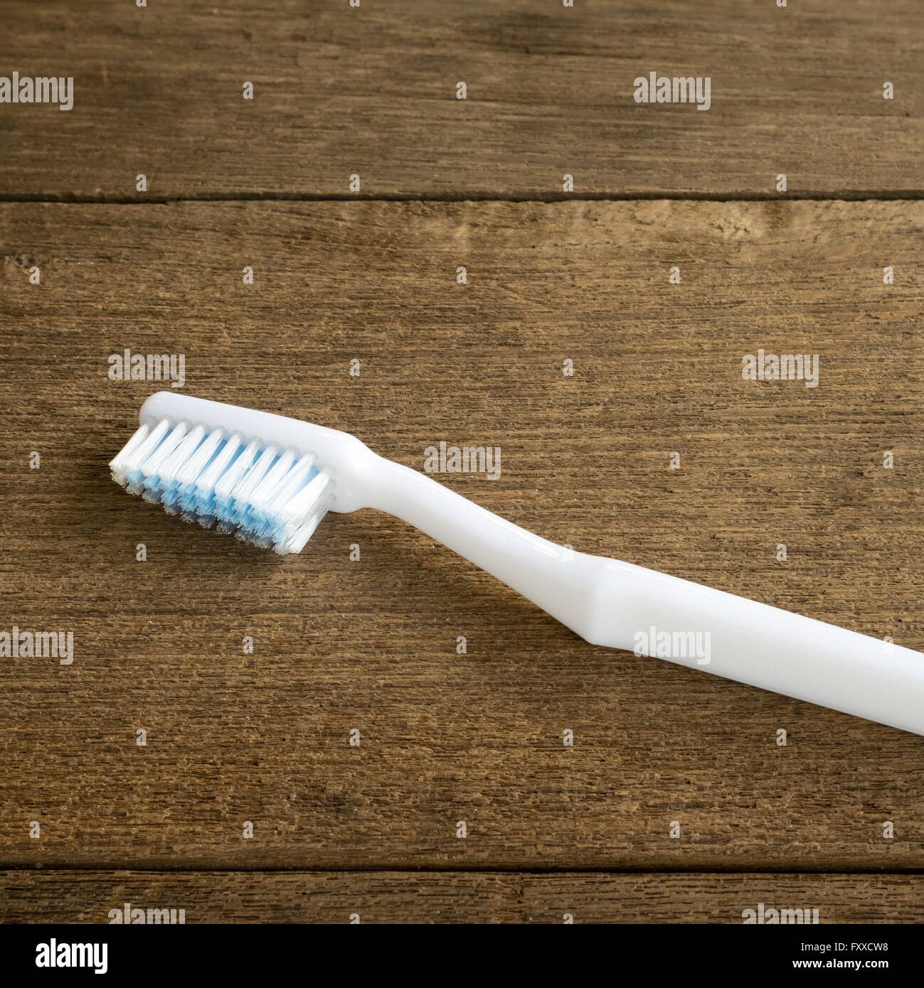 The clean white toothbrush on old wooden planks for brushing the teeth ...