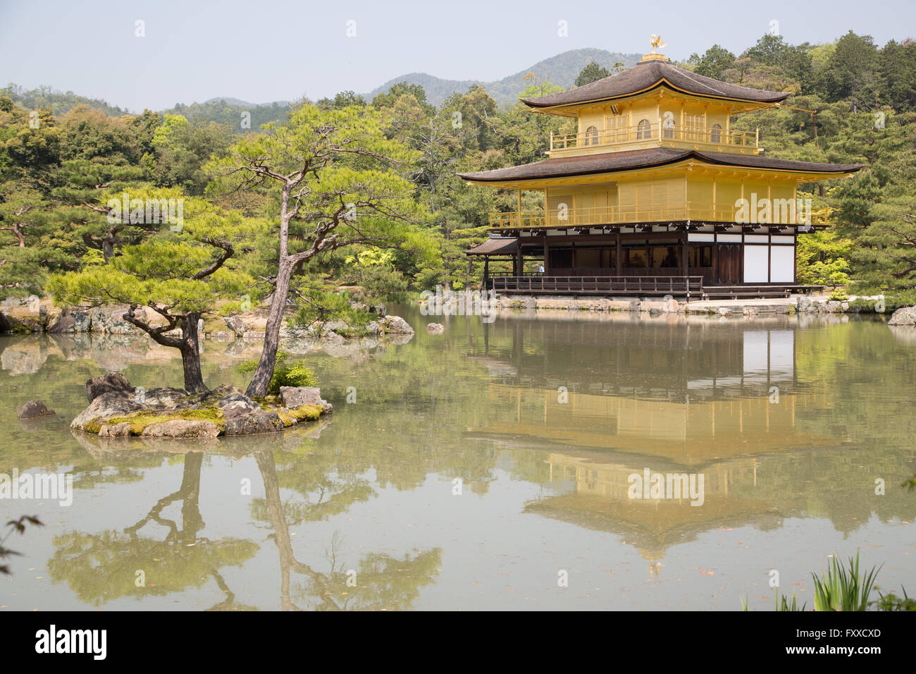 The reflection of Kinkaku-ji, known as the Golden Pavilion, surrounded ...