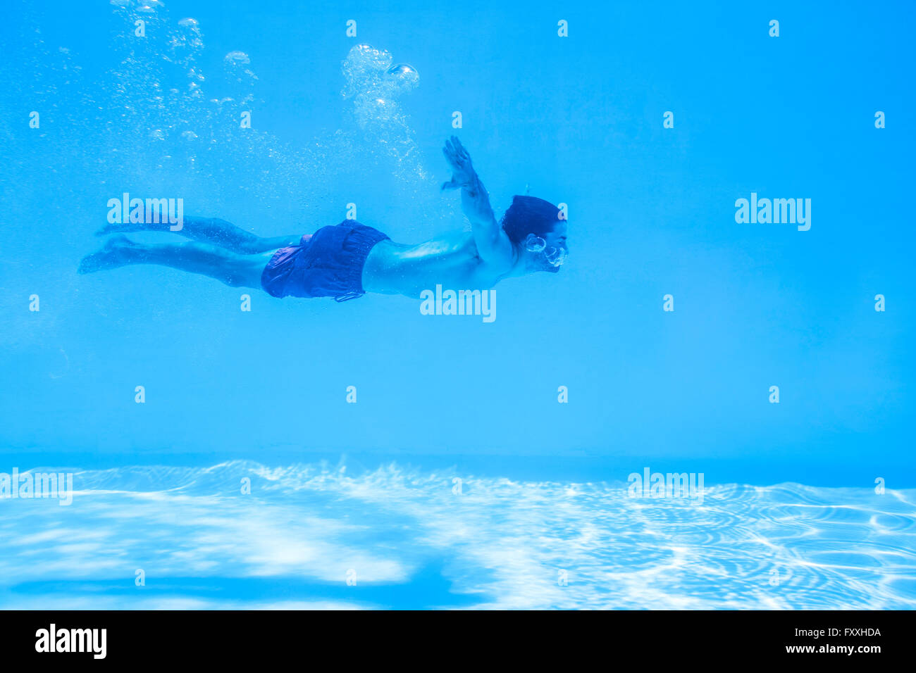 Man swimming underwater in swimming pool Stock Photo - Alamy