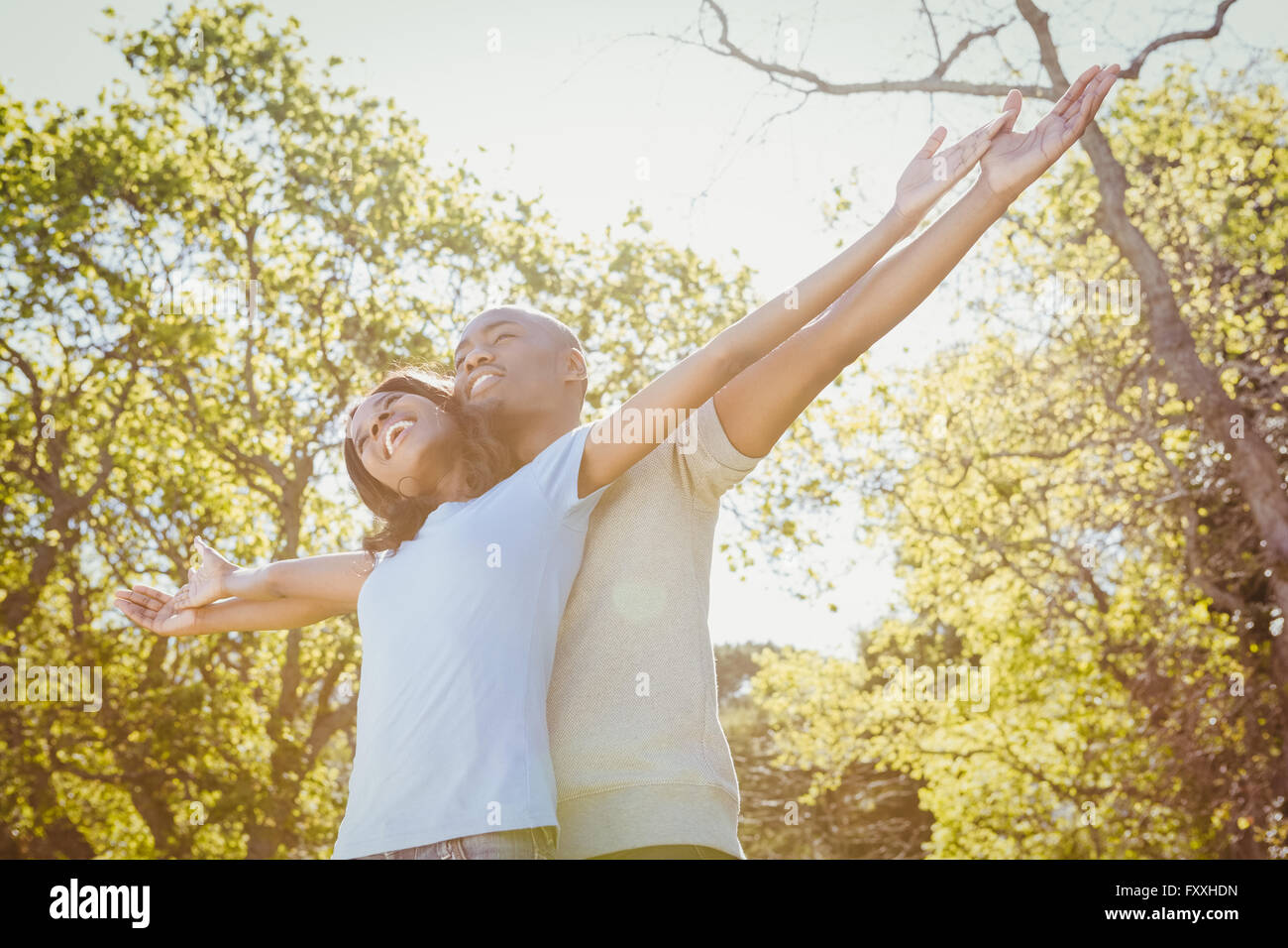 Young couple arms outstretched and having fun Stock Photo - Alamy