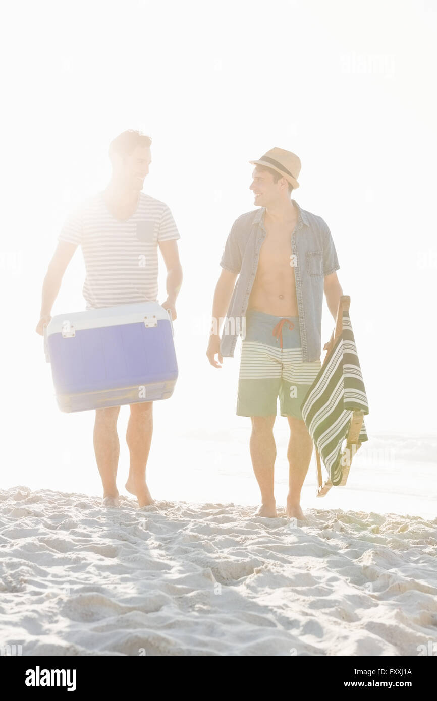 Handsome friends holding cooler Stock Photo - Alamy