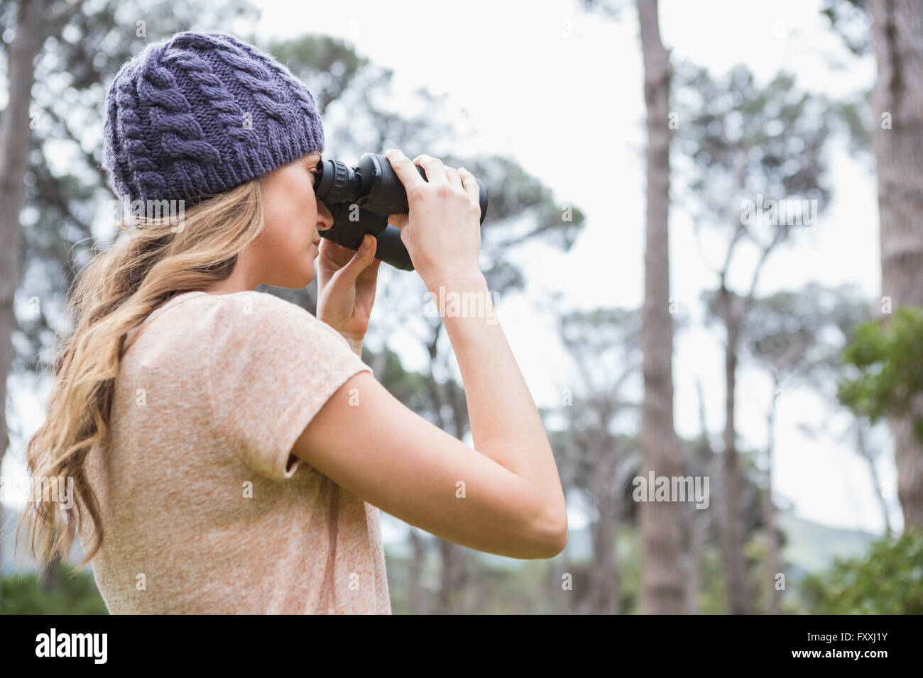Woman using binoculars Stock Photo - Alamy