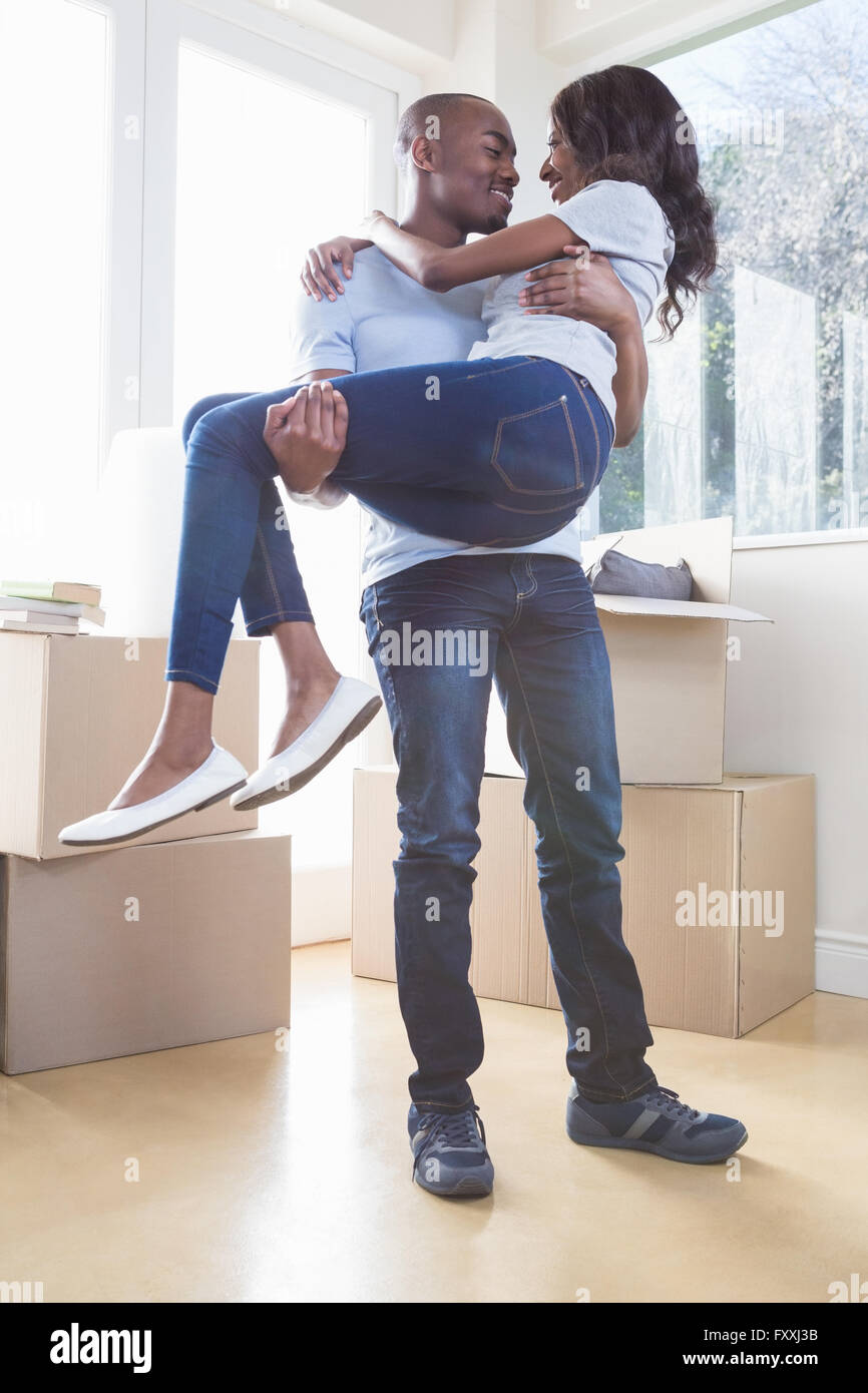 Young man lifting woman in his arms Stock Photo - Alamy