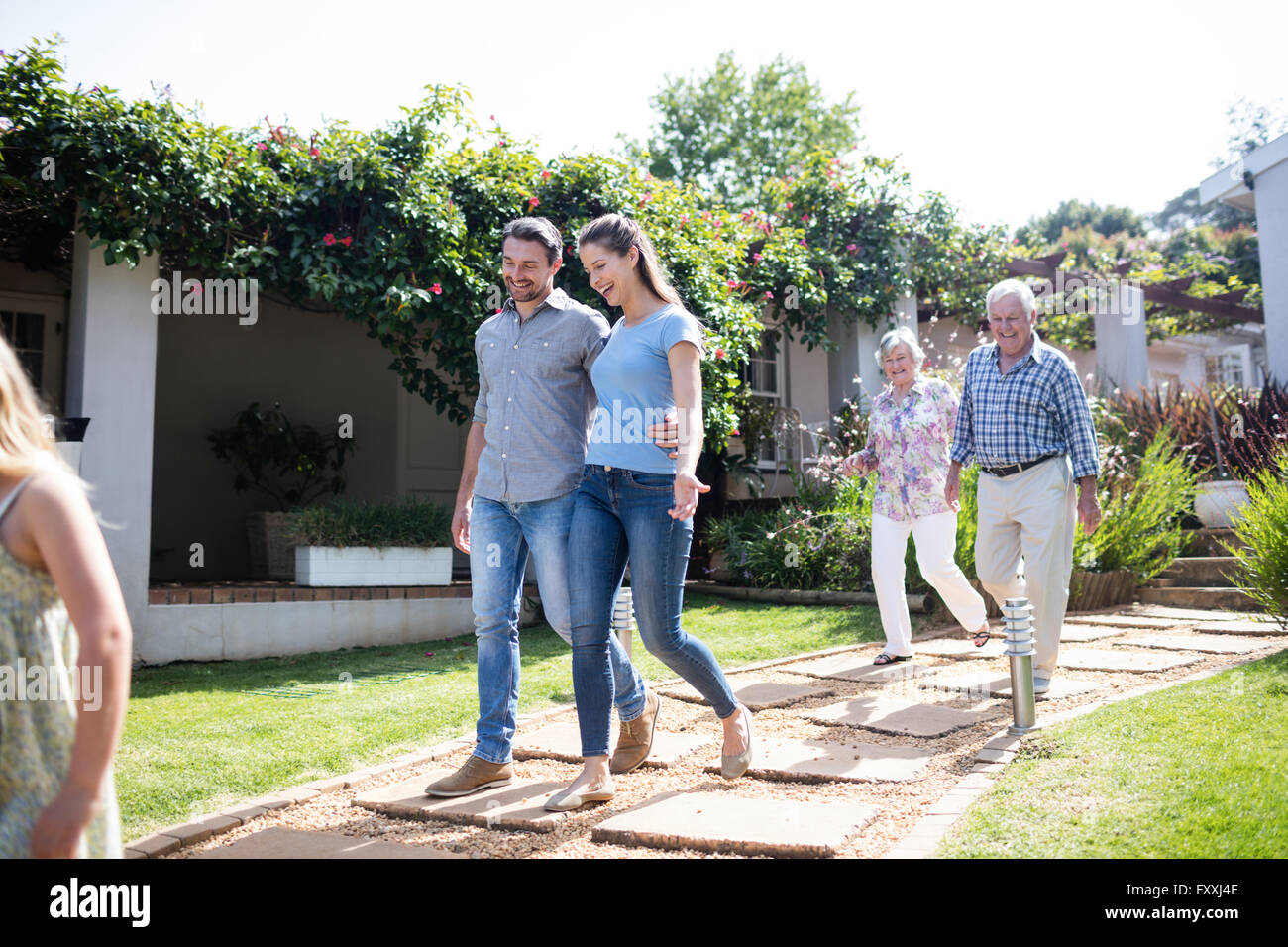 Multi-generation family walking on the garden path Stock Photo - Alamy