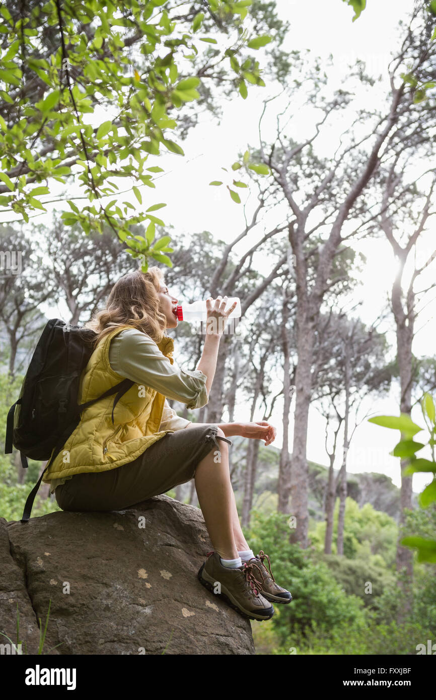Woman sitting on a stone Stock Photo - Alamy