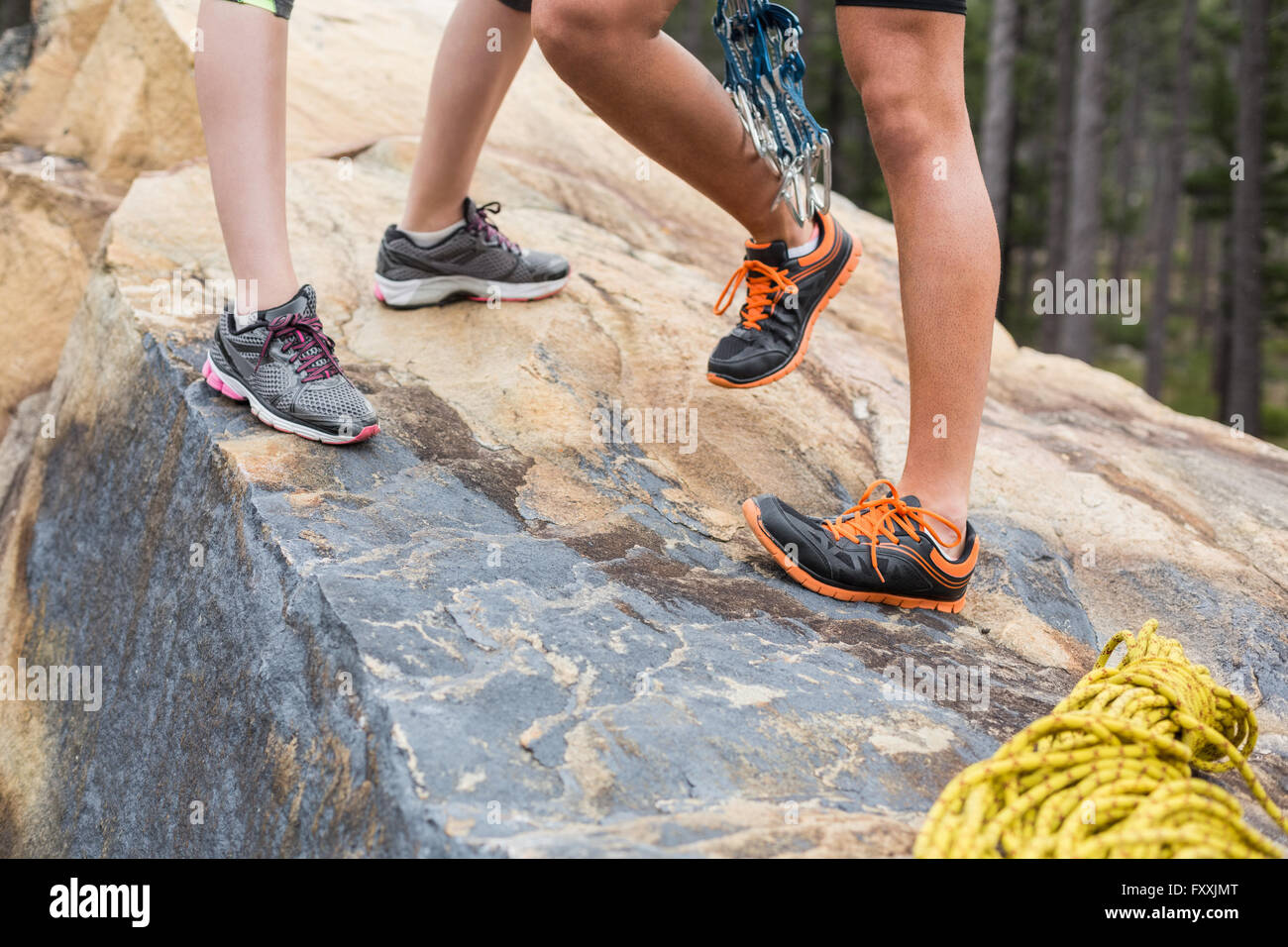 Low section of people standing on rock Stock Photo - Alamy