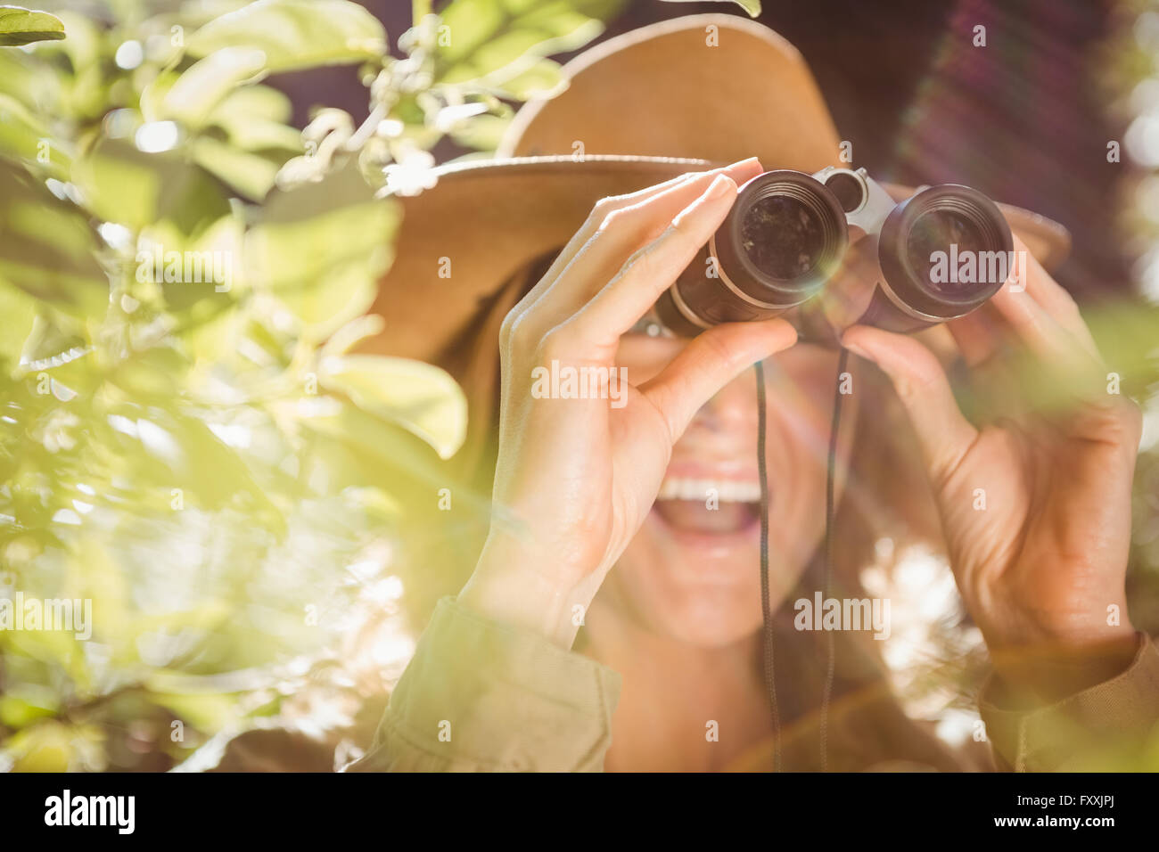 Woman using binoculars Stock Photo - Alamy