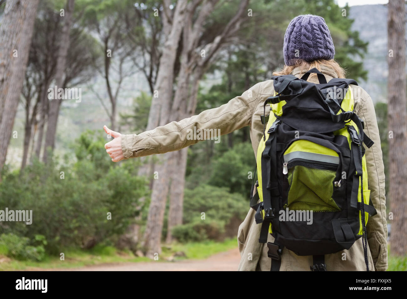 Hitch hiking woman with backpack Stock Photo - Alamy