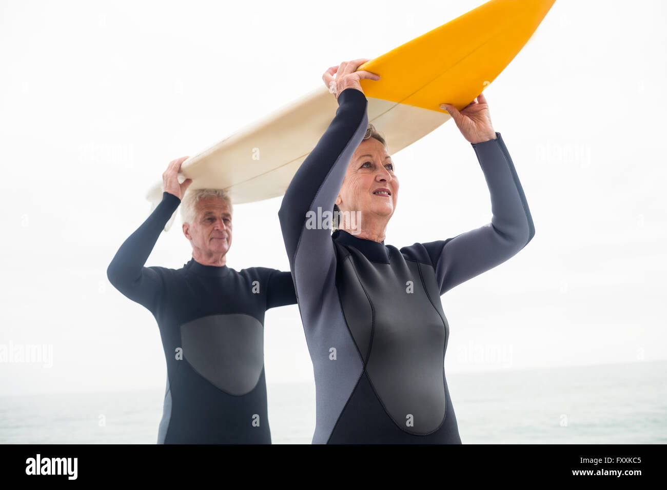 Happy man and woman with surfboard hi-res stock photography and images ...
