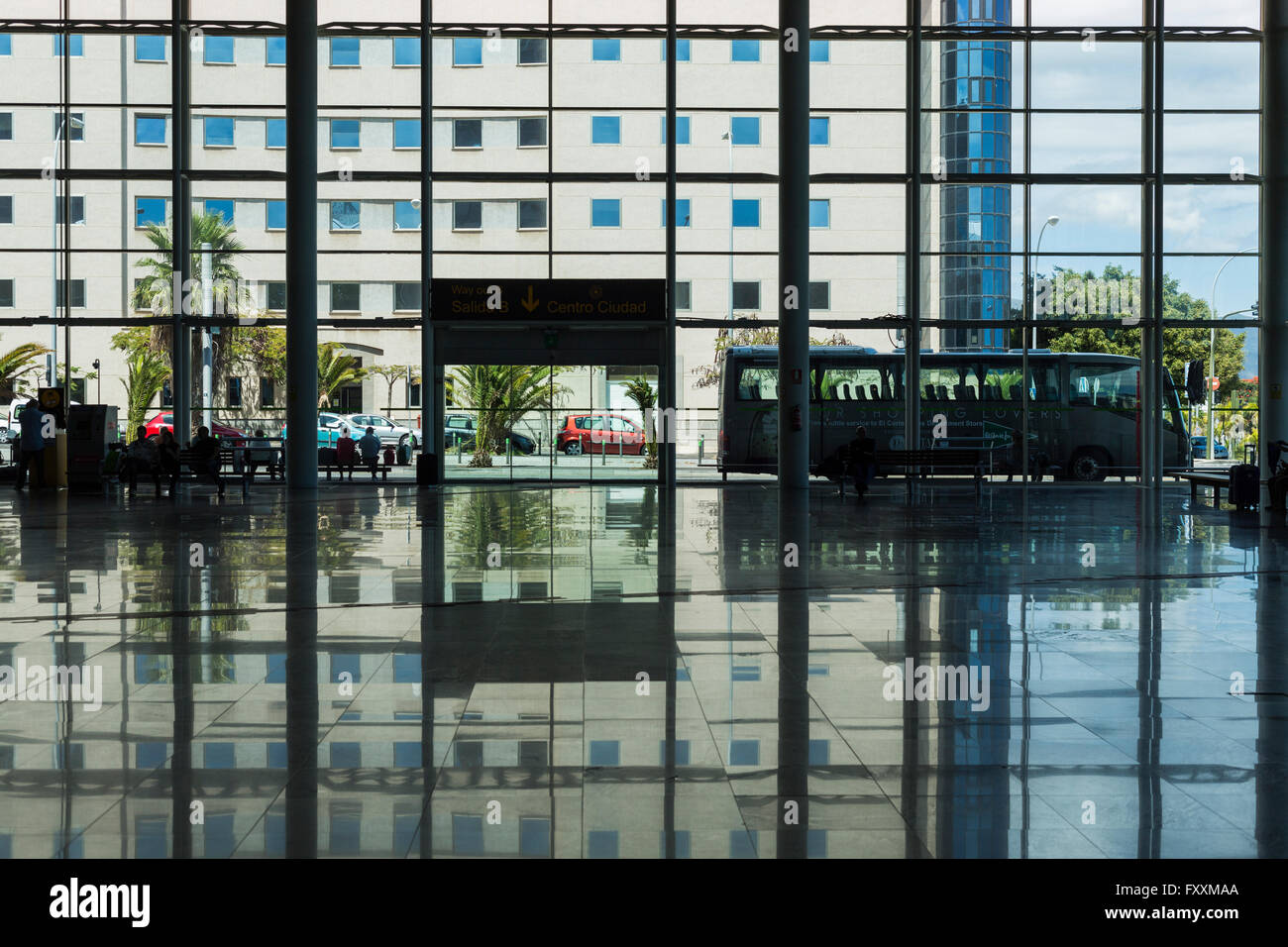 Highly polished floor reflecting the glass walls inside the bus station ...